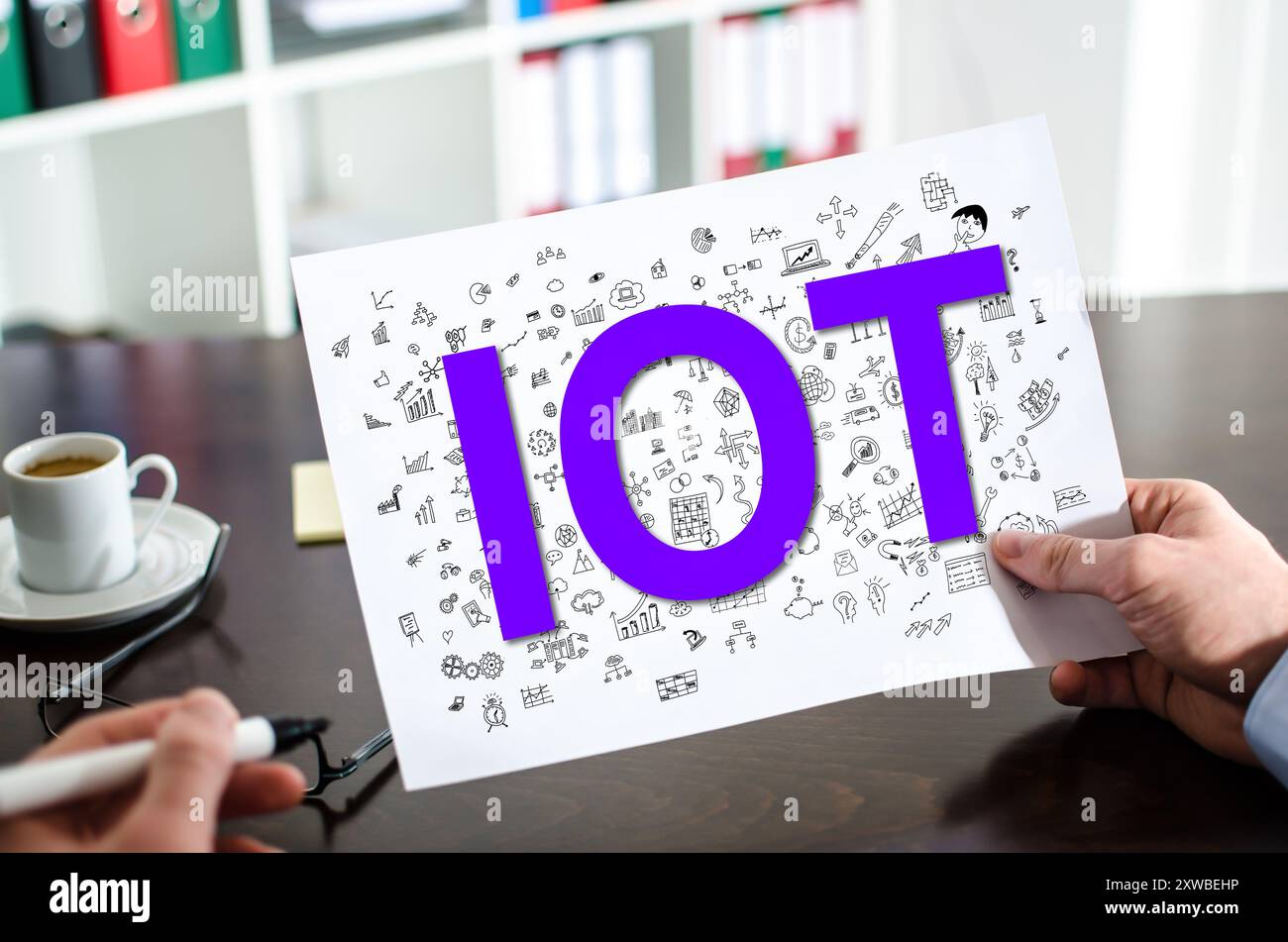 Hand holding a paper showing iot concept Stock Photo - Alamy