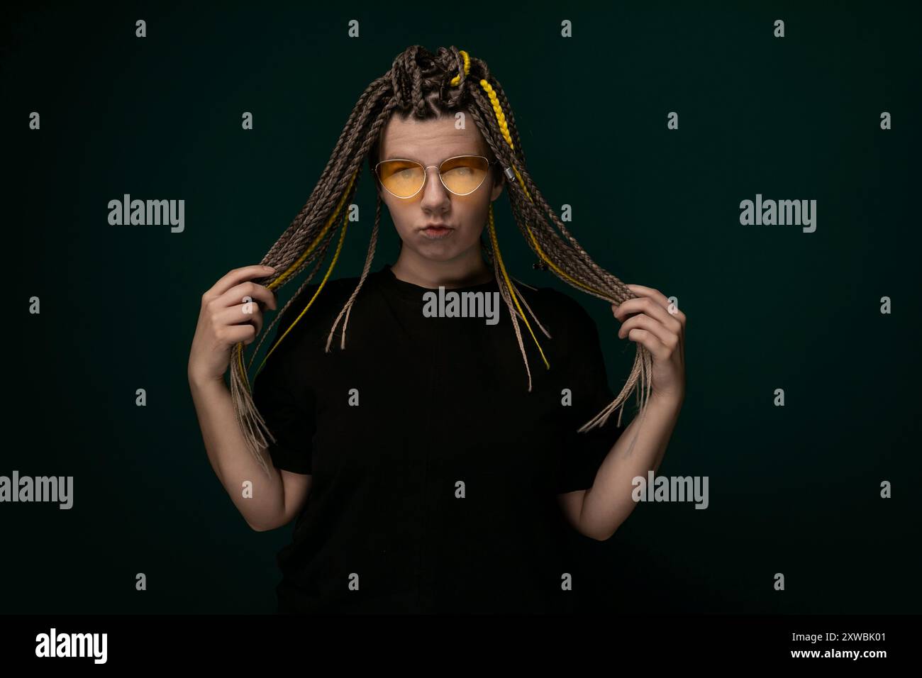 Woman With Dreadlocks Holding Hair in Front of Face Stock Photo - Alamy