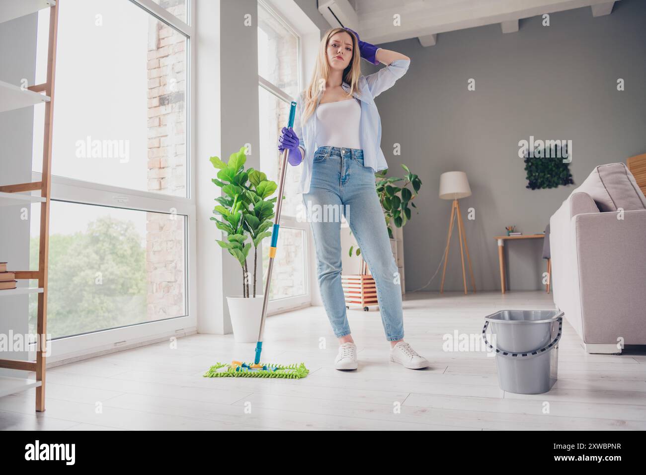 Photo of sad depressed girl dressed blue shirt dislike doing housework ...