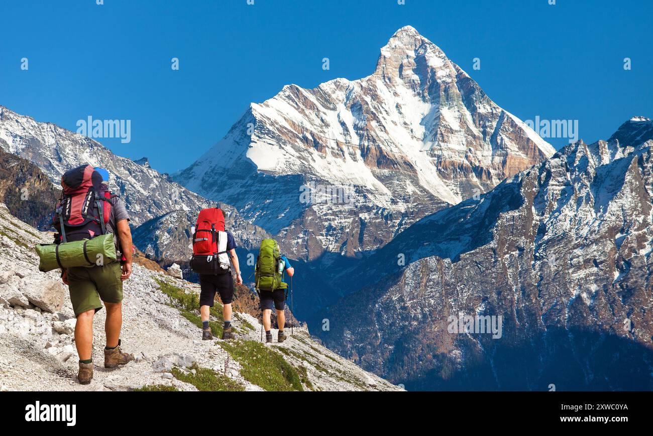 mount Nanda Devi with three hikers, one of the best mounts in Indian ...