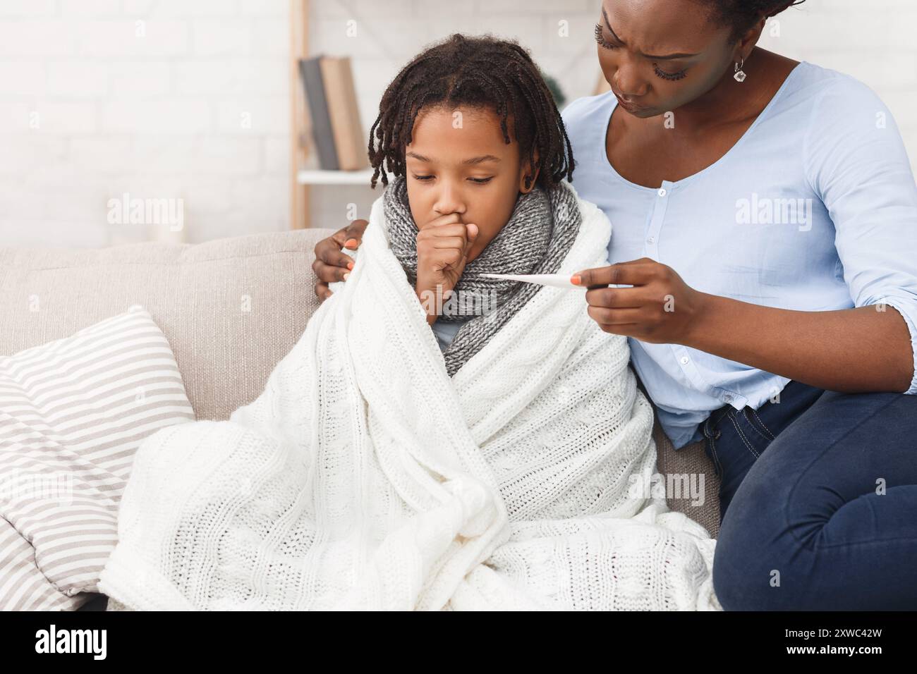 Mother measuring temperature of her sick daughter with thermometer Stock Photo - Alamy