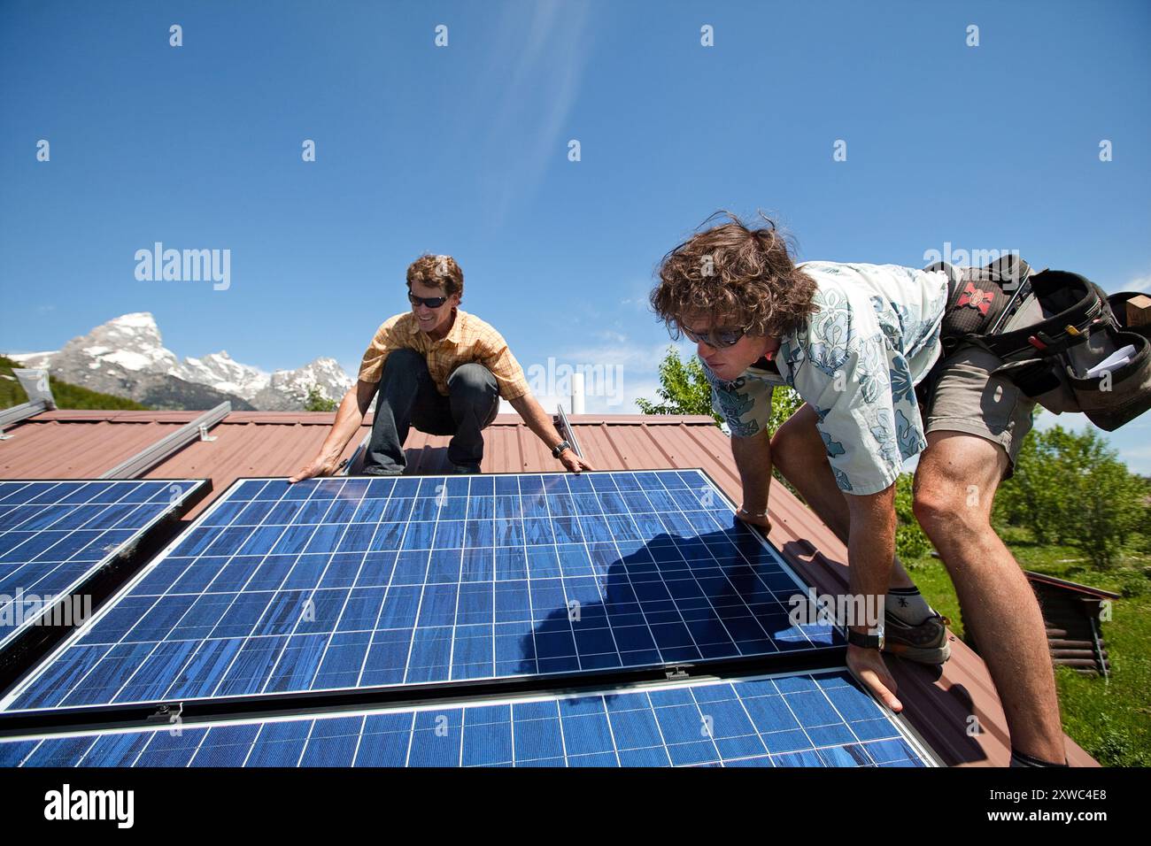 Two men perform an installation of a photovoltaic panel at the Grand ...
