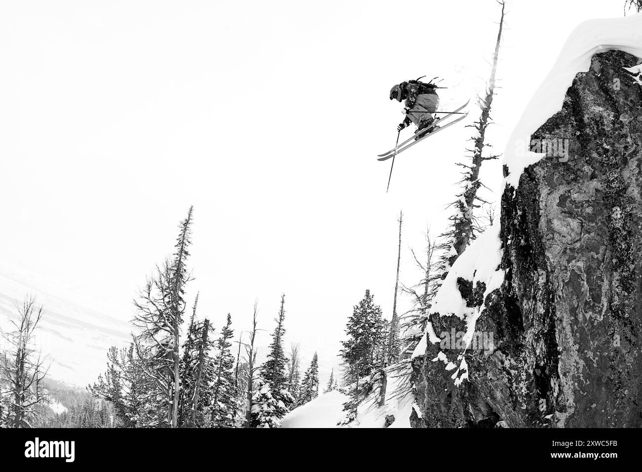 A professional big mountain skier jumps off a cliff in the Jackson Hole ...