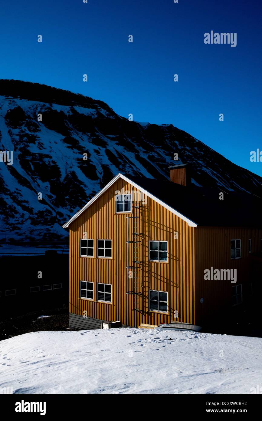 Yellow building in snowy Longyearbyen, Svalbard Stock Photo - Alamy