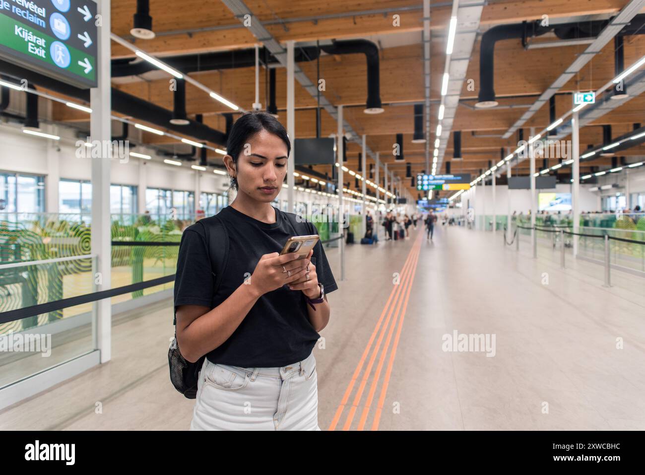 Female traveler checking flight information hi-res stock photography and images - Alamy
