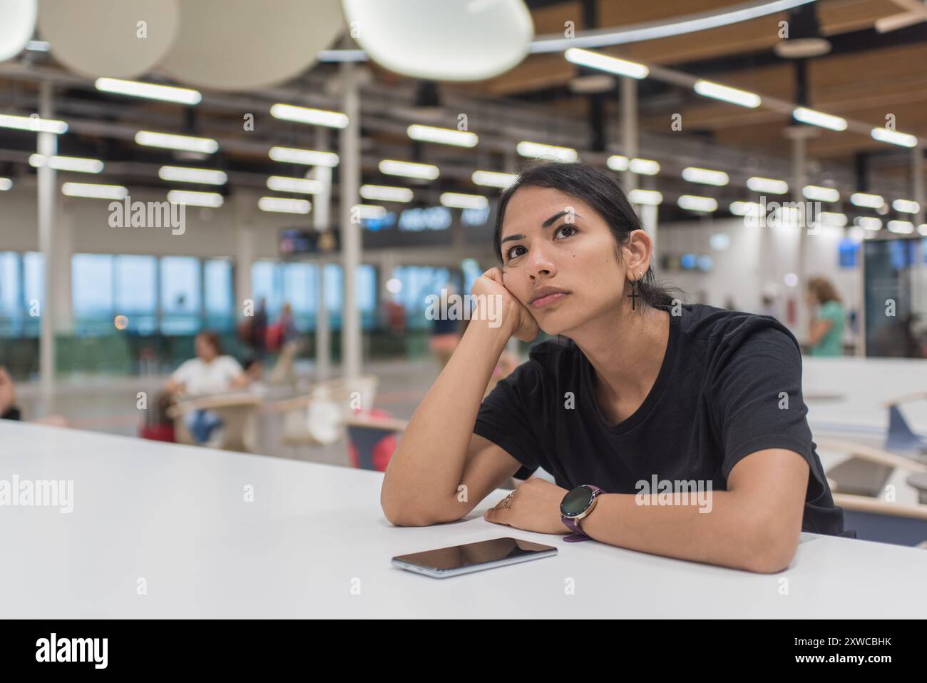 Woman bored in the airport terminal waiting for her flight Stock Photo ...