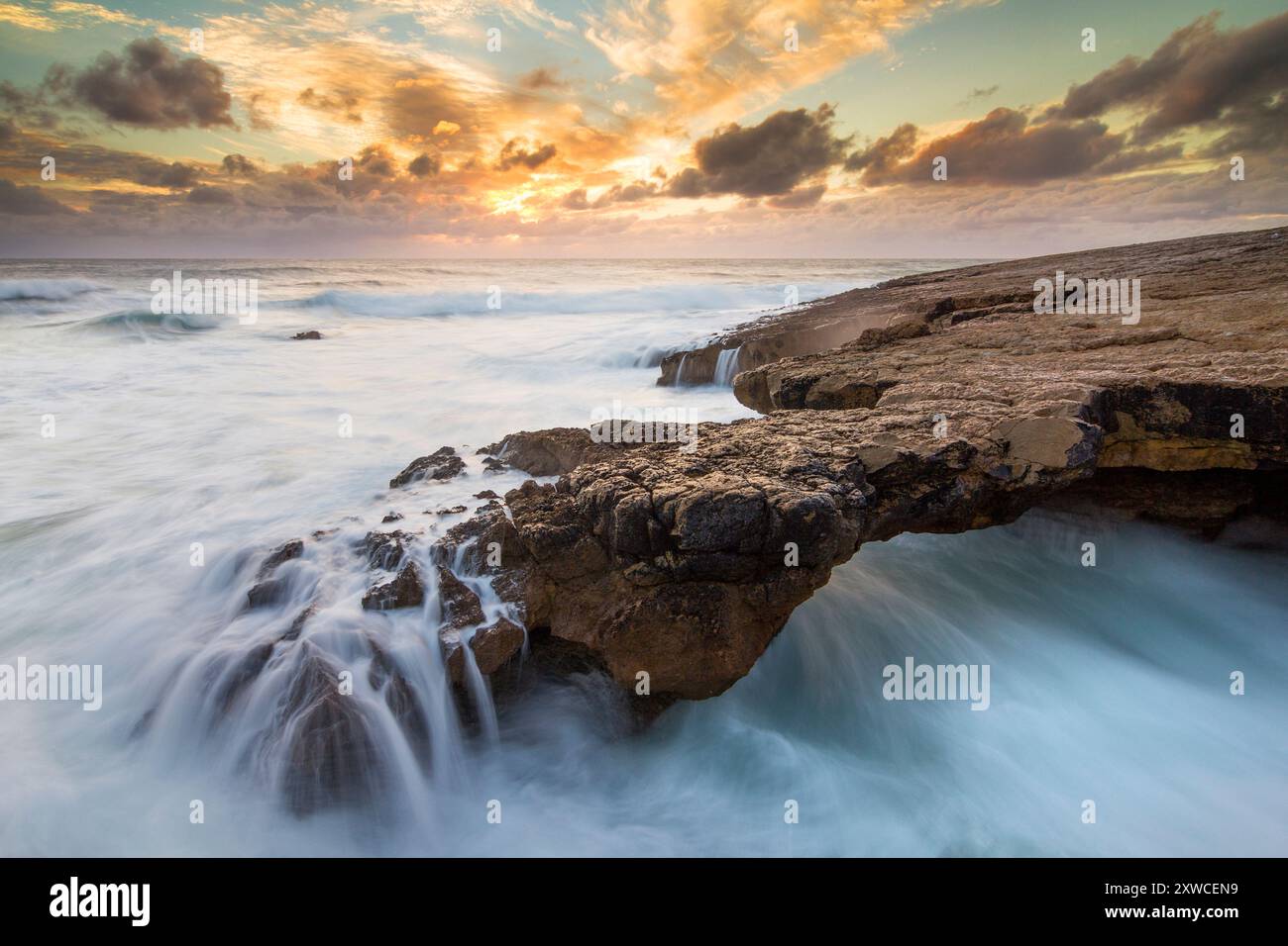 stone arch in the ocean in Portugal waterfall Stock Photo - Alamy