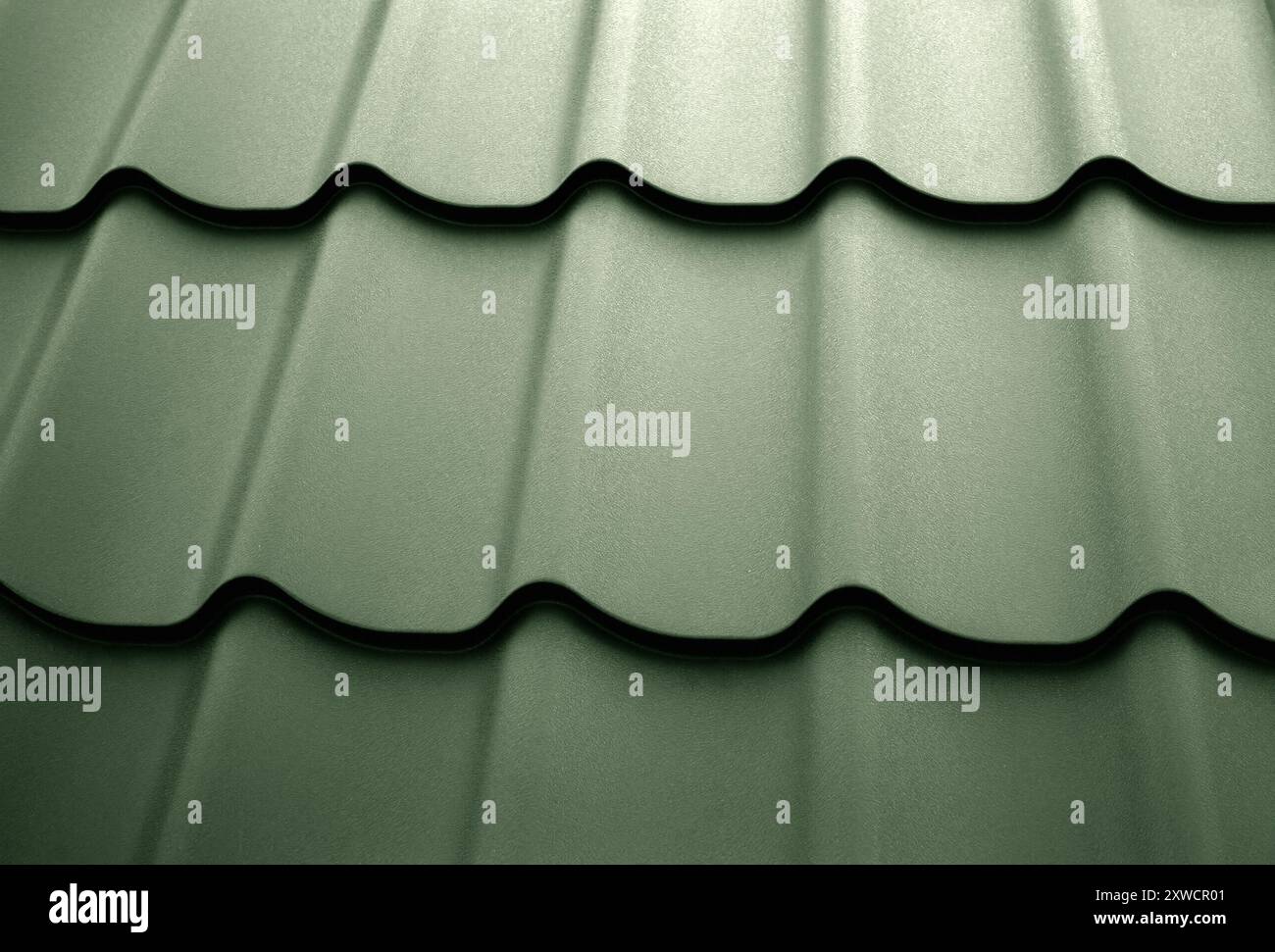 Close-up view lightweight steel roofing sheet. Green color coated ...