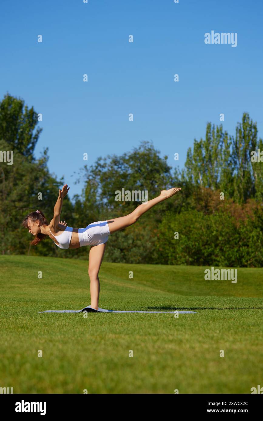 Focused on yoga practice, woman strengthens core and improves ...
