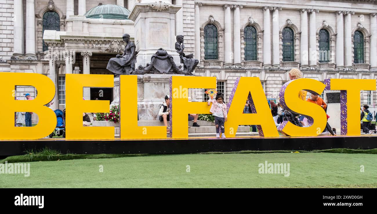 large yellow sign outside City Hall that reads BELFAST in capital ...