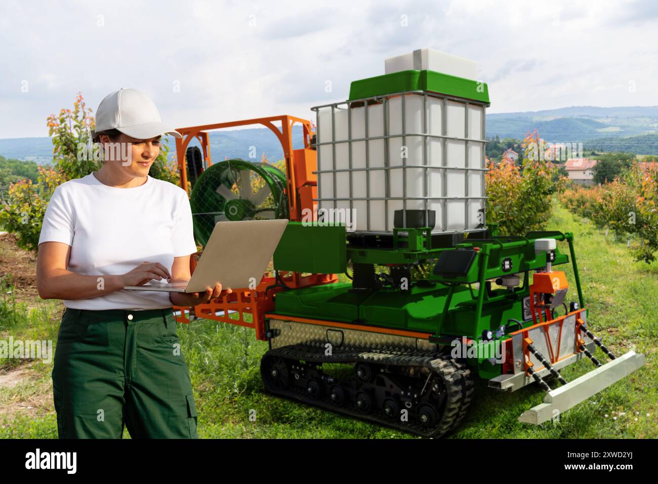 Farmer controls autonomous robot sprayer in a fruit garden. Smart ...