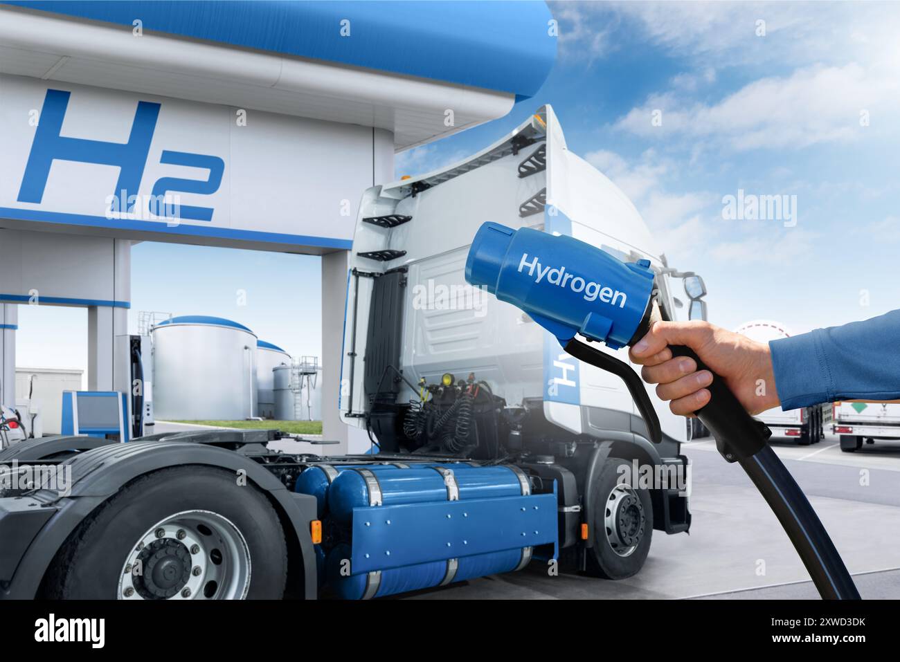 Hand with H2 nozzle on a background of hydrogen fuel cell semi truck ...