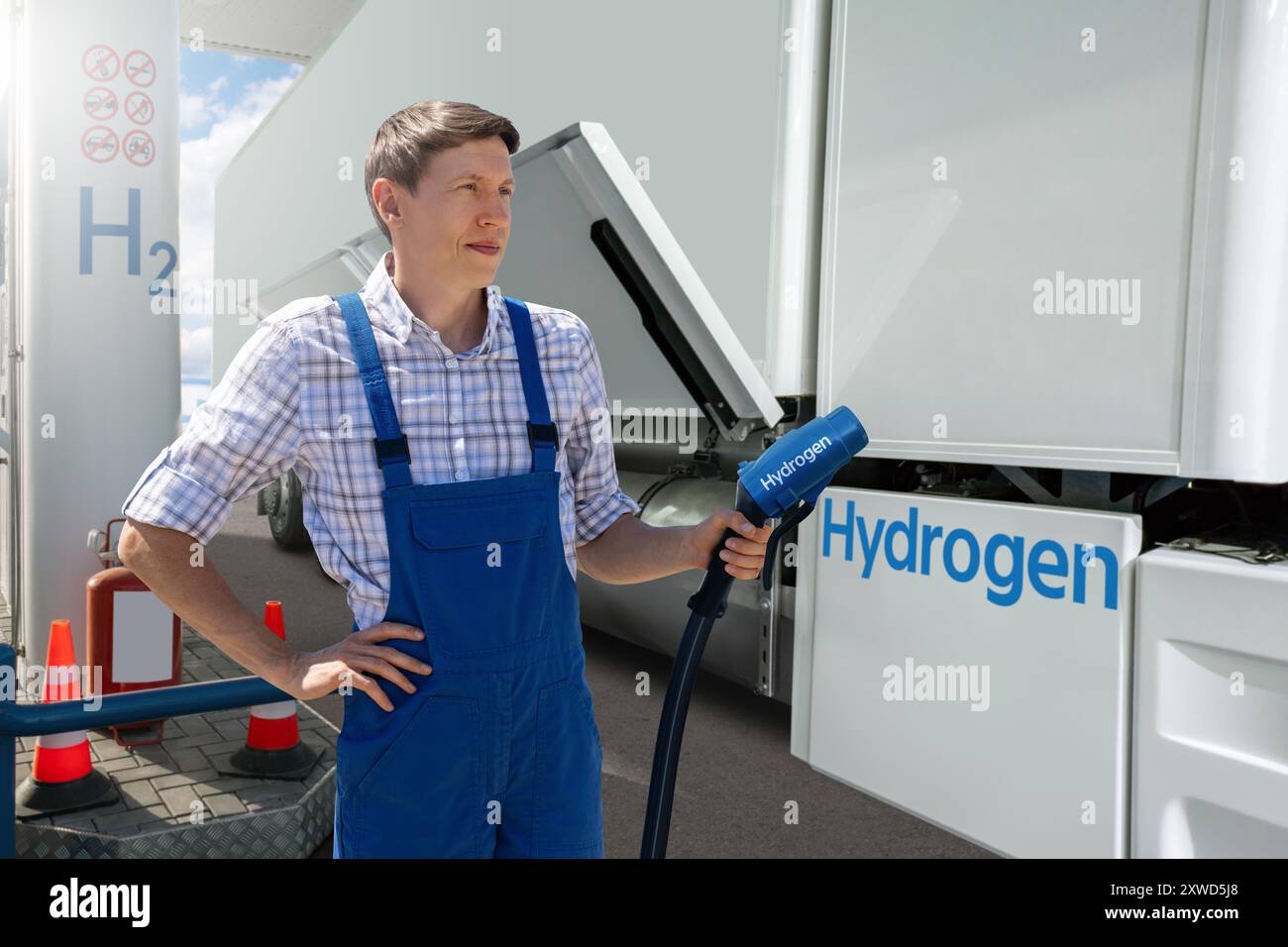Man with H2 nozzle on a background of hydrogen fuel cell semi truck ...