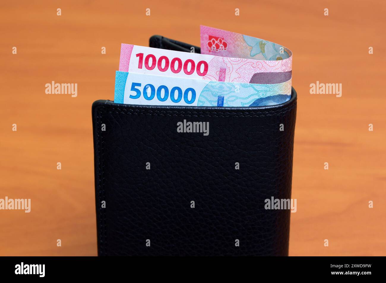 Indonesian money - rupiah in the black wallet Stock Photo - Alamy
