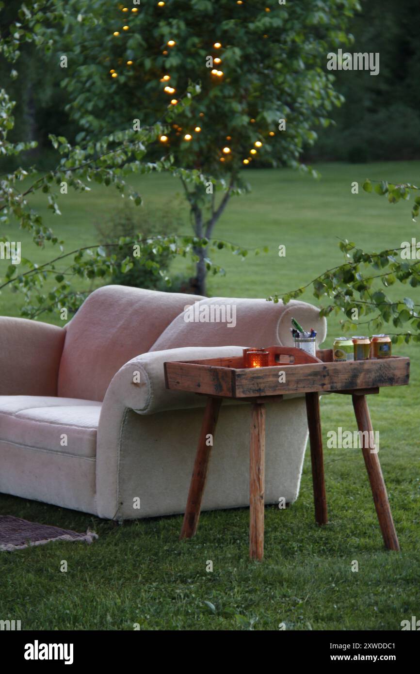 Cozy sofa on a green lawn on a summer's night in Sweden Stock Photo - Alamy