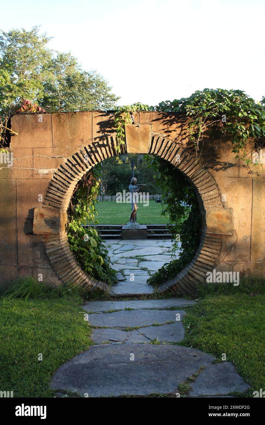 Stone arch in old lush garden in Sweden Stock Photo - Alamy