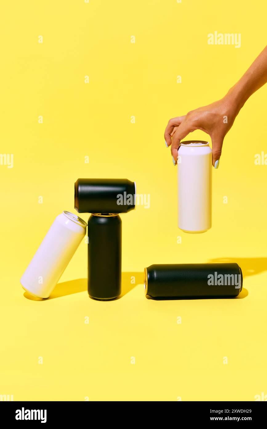 Minimalistic mockup with black and white cans on yellow background ...