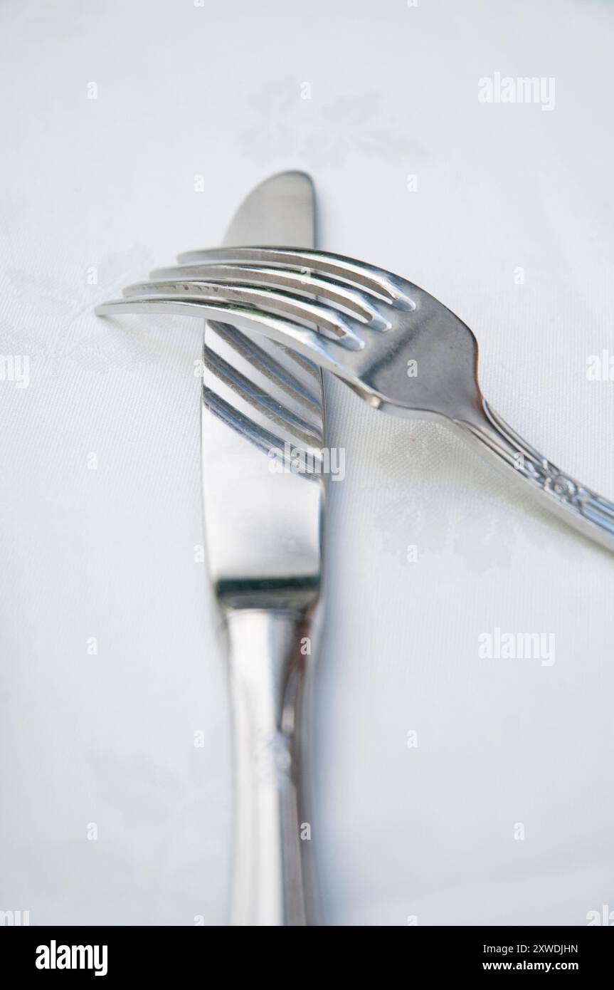 Crossed fork and knife Stock Photo - Alamy