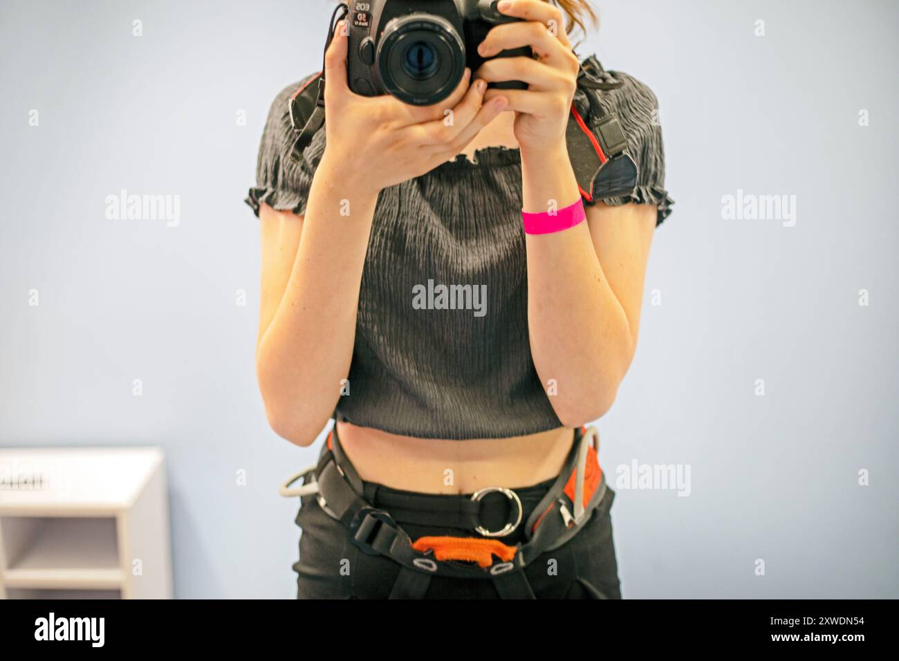 teenage girl takes pictures with a professional camera. Hobbies and ...