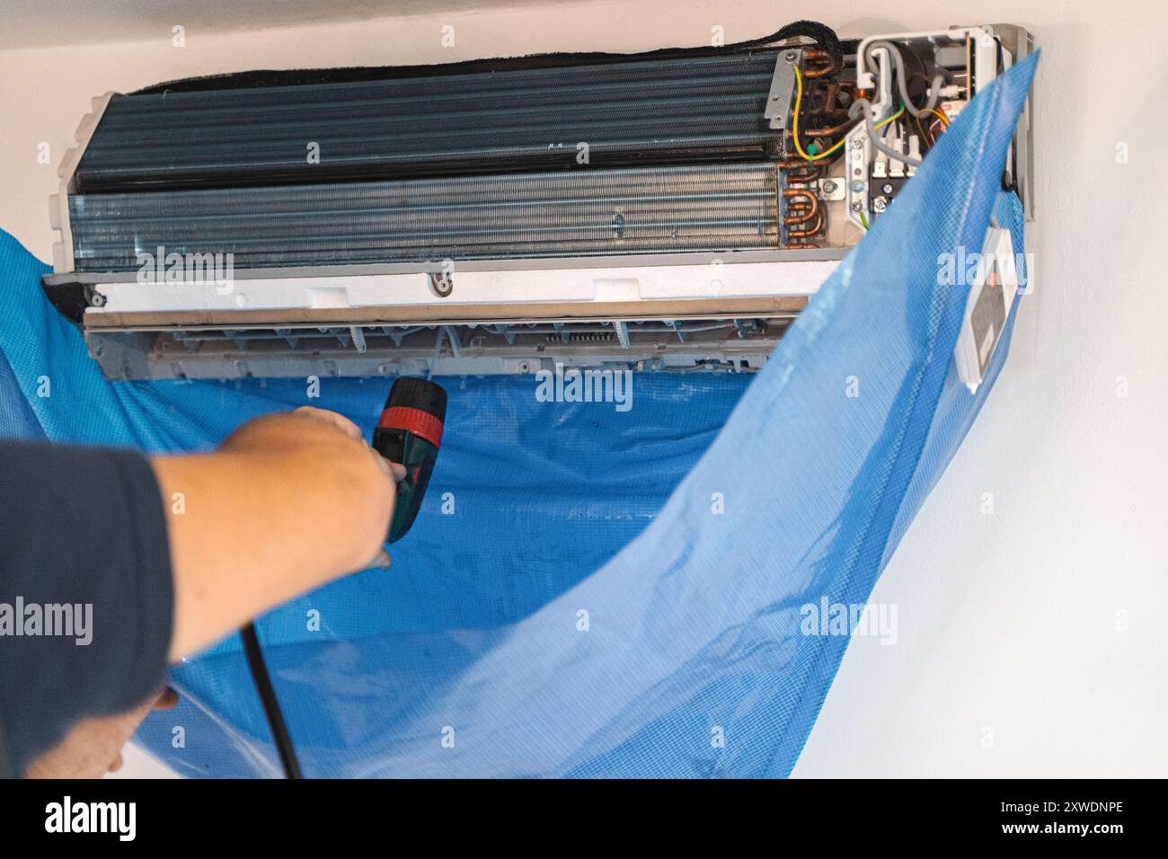 The technician are cleaning the air conditioner by spraying water Stock ...