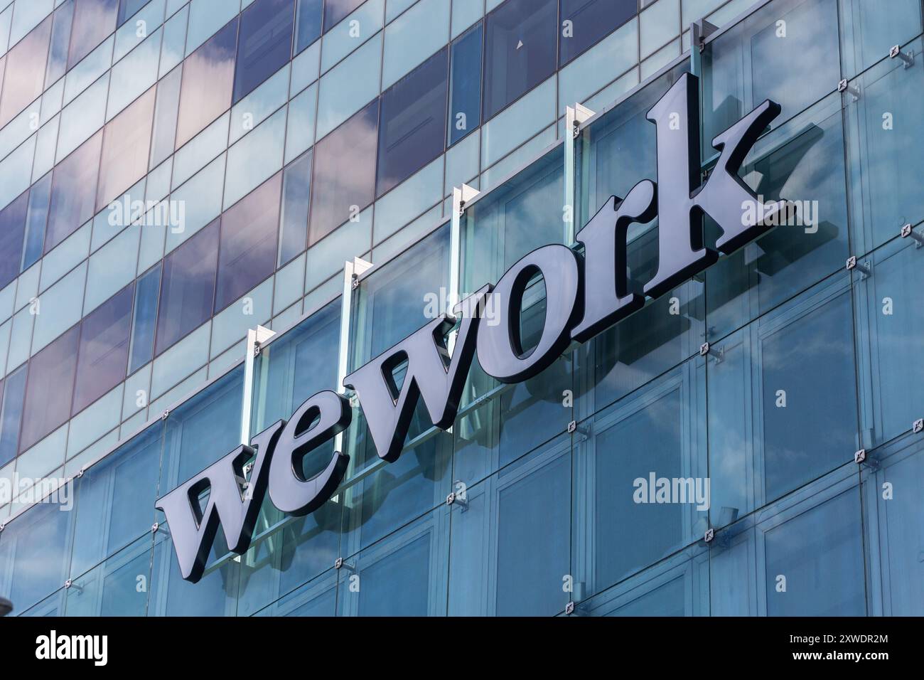 19 Aug 2024. Wework signage attached on curtain walls at an outdoor ...