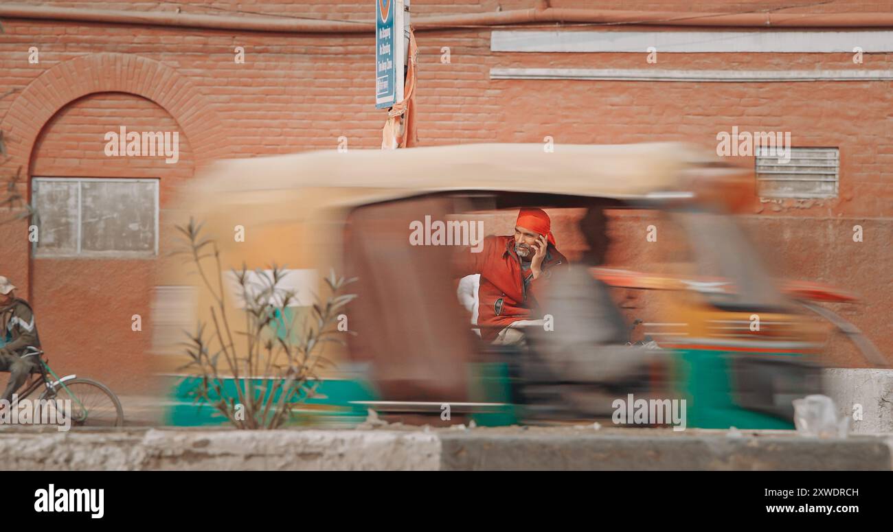 New Delhi, Delhi, India. Indian man carries loaded cargo on a cargo ...