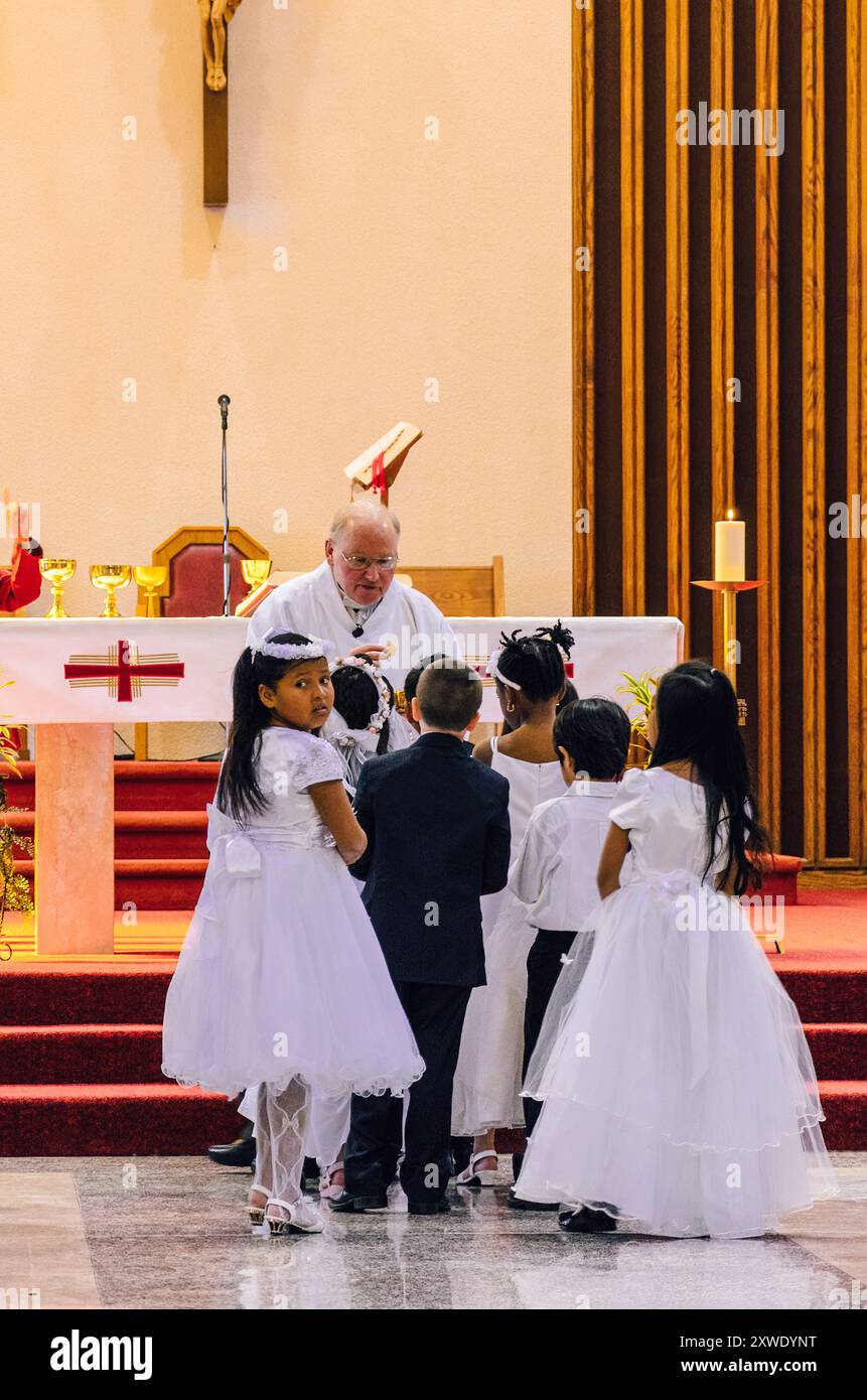 Group of children during a first communion ceremony inside a Catholic ...