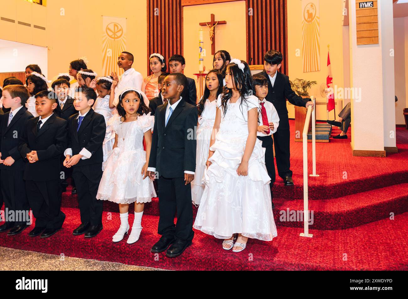 Group of children during a first communion ceremony inside a Catholic ...