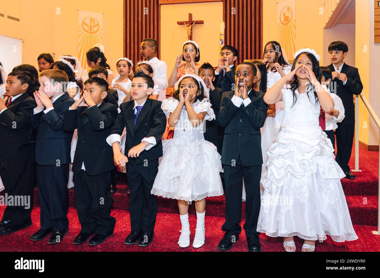 Group of children during a first communion ceremony inside a Catholic ...
