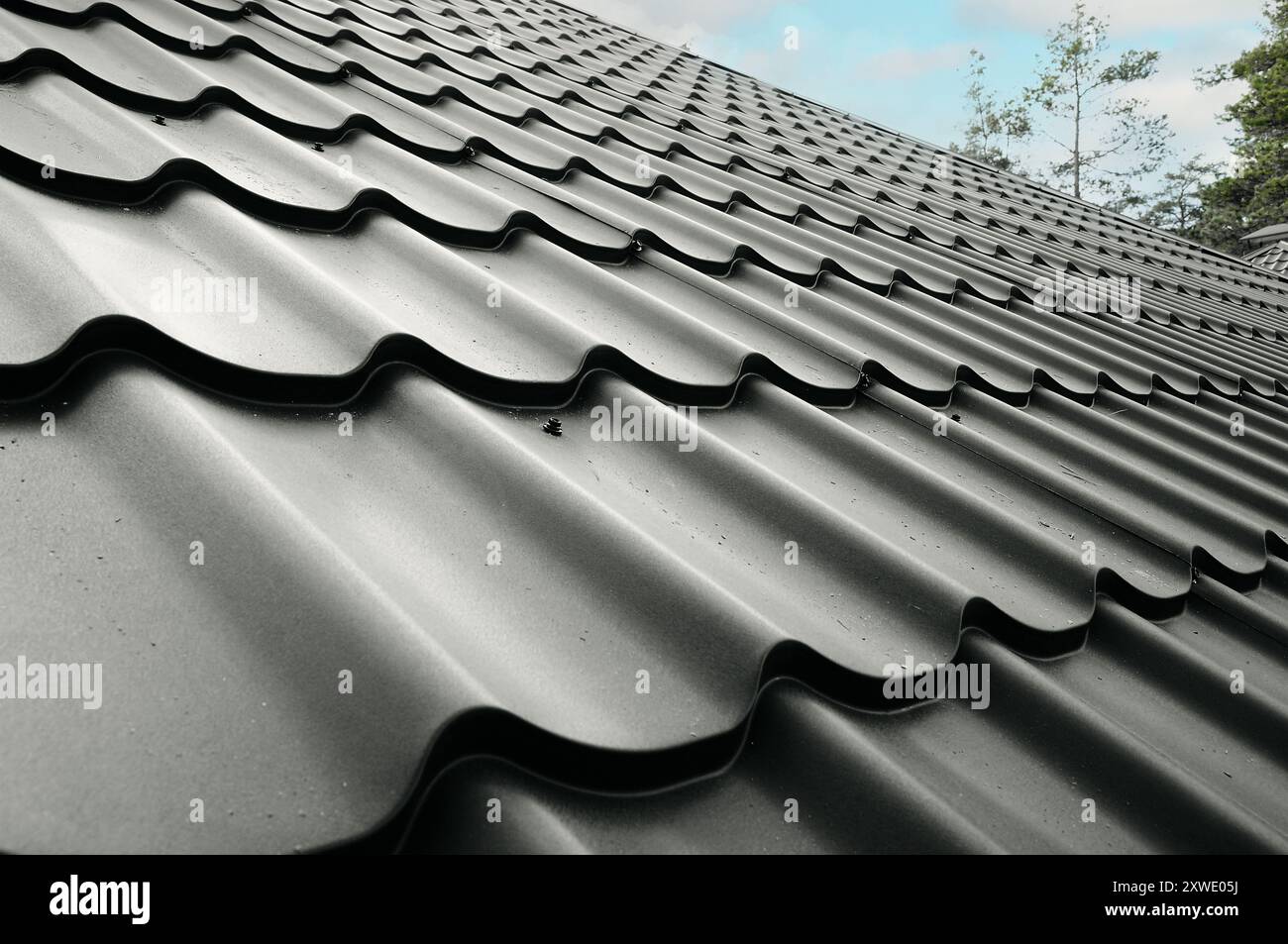 Close-up house roof with steel roofing sheet. Gray modular tile effect ...