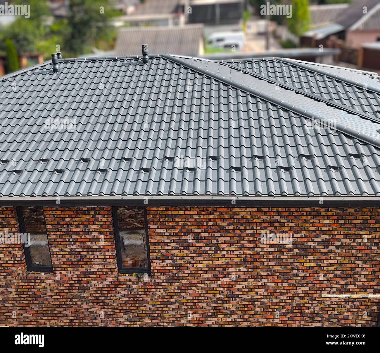 Close-up house roof with steel roofing sheet. Gray modular tile effect ...