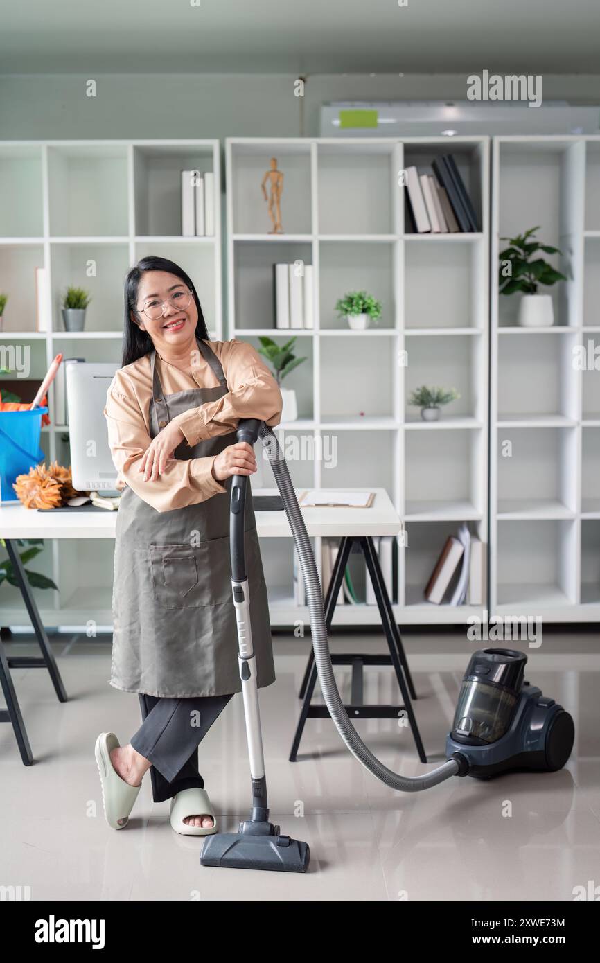 Smiling Housekeeper Standing with Vacuum in Clean Modern Office Stock ...
