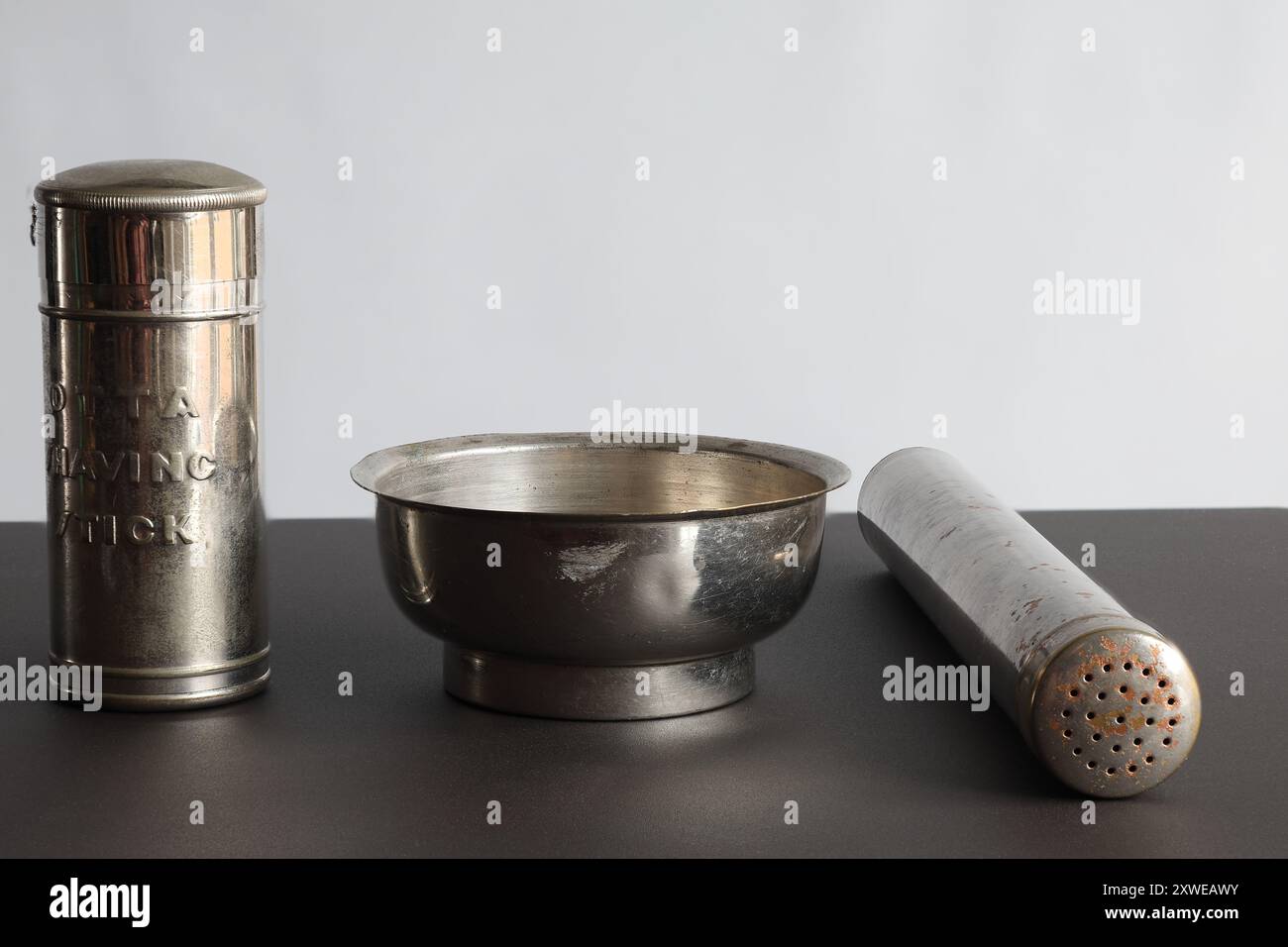 Still life with vintage shaving stick box, toothbrush container and ...