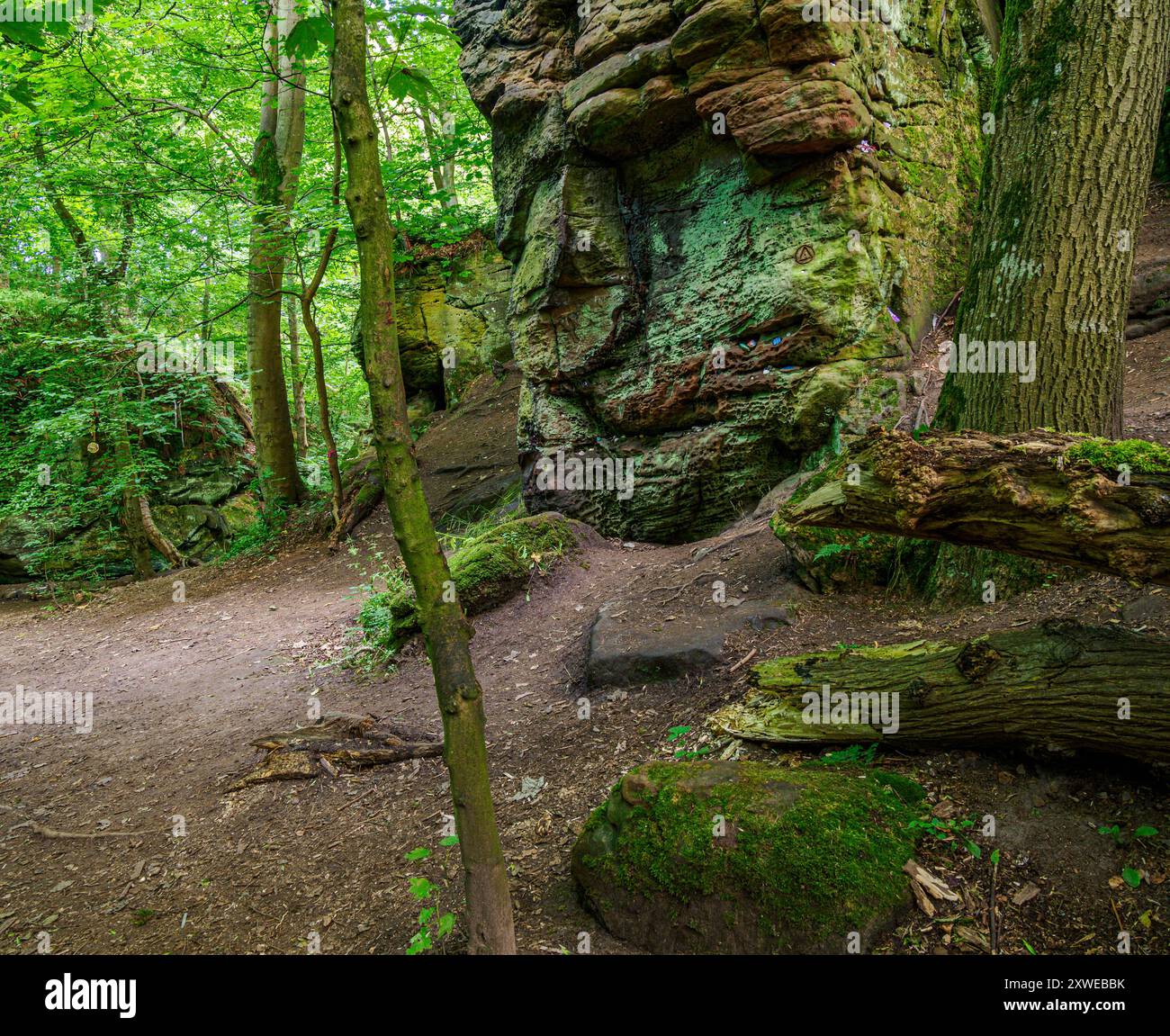 Carved into the rocks are many etchings such as Celtic crosses, human ...