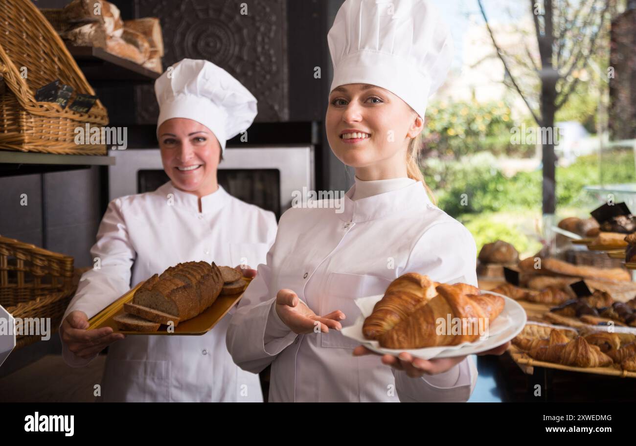 Women workers in a bakery posing with pastries Stock Photo - Alamy
