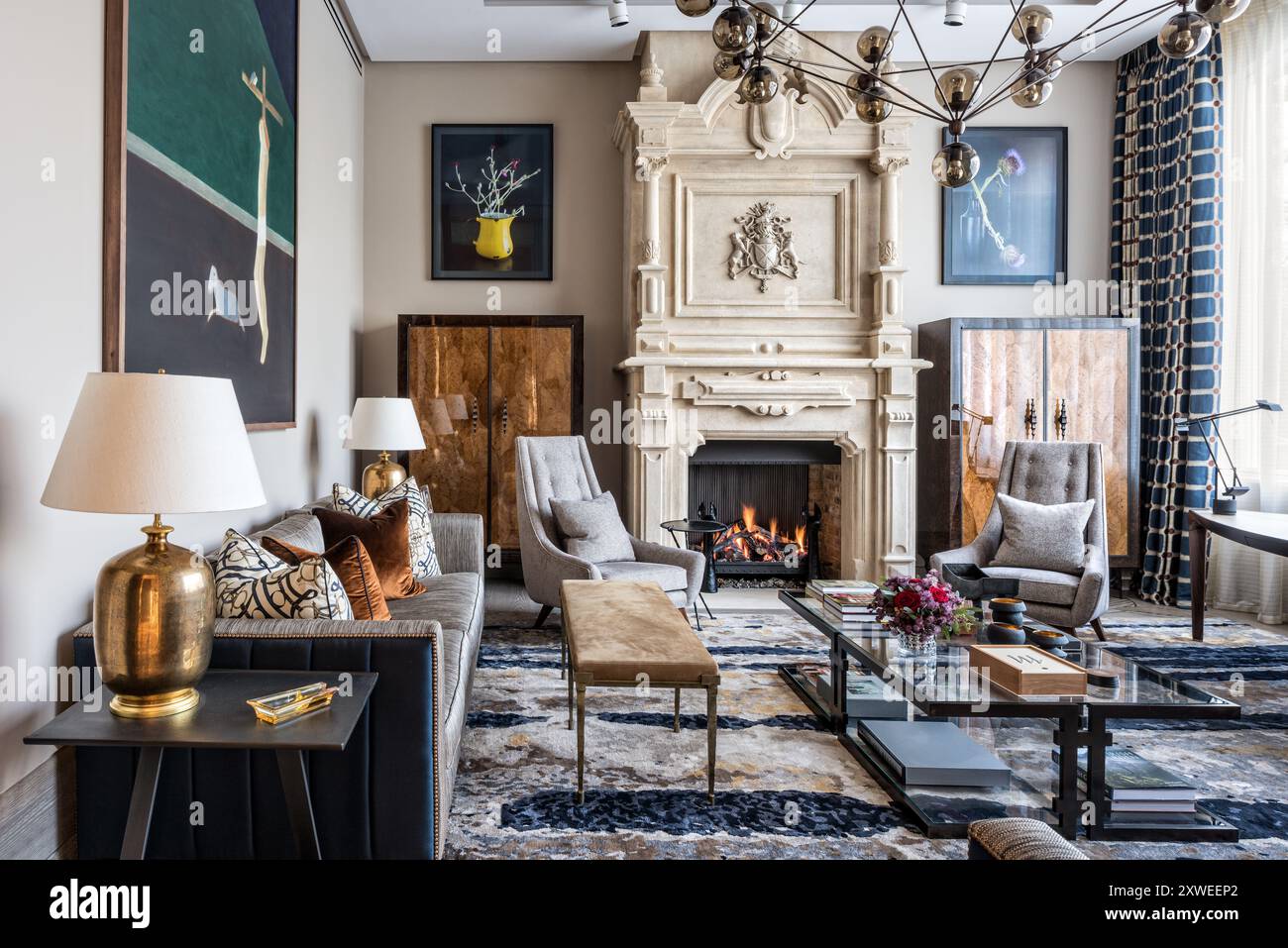 Lit fire in living room of luxury modern British home in London, UK ...