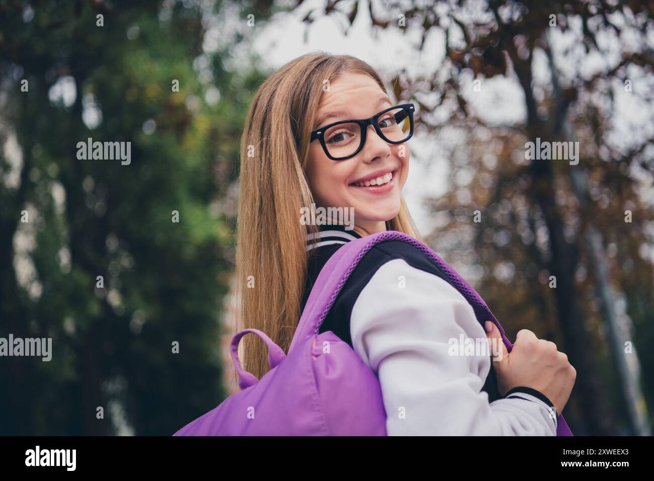 Photo portrait of pretty teen girl look camera turn around toothy smile ...