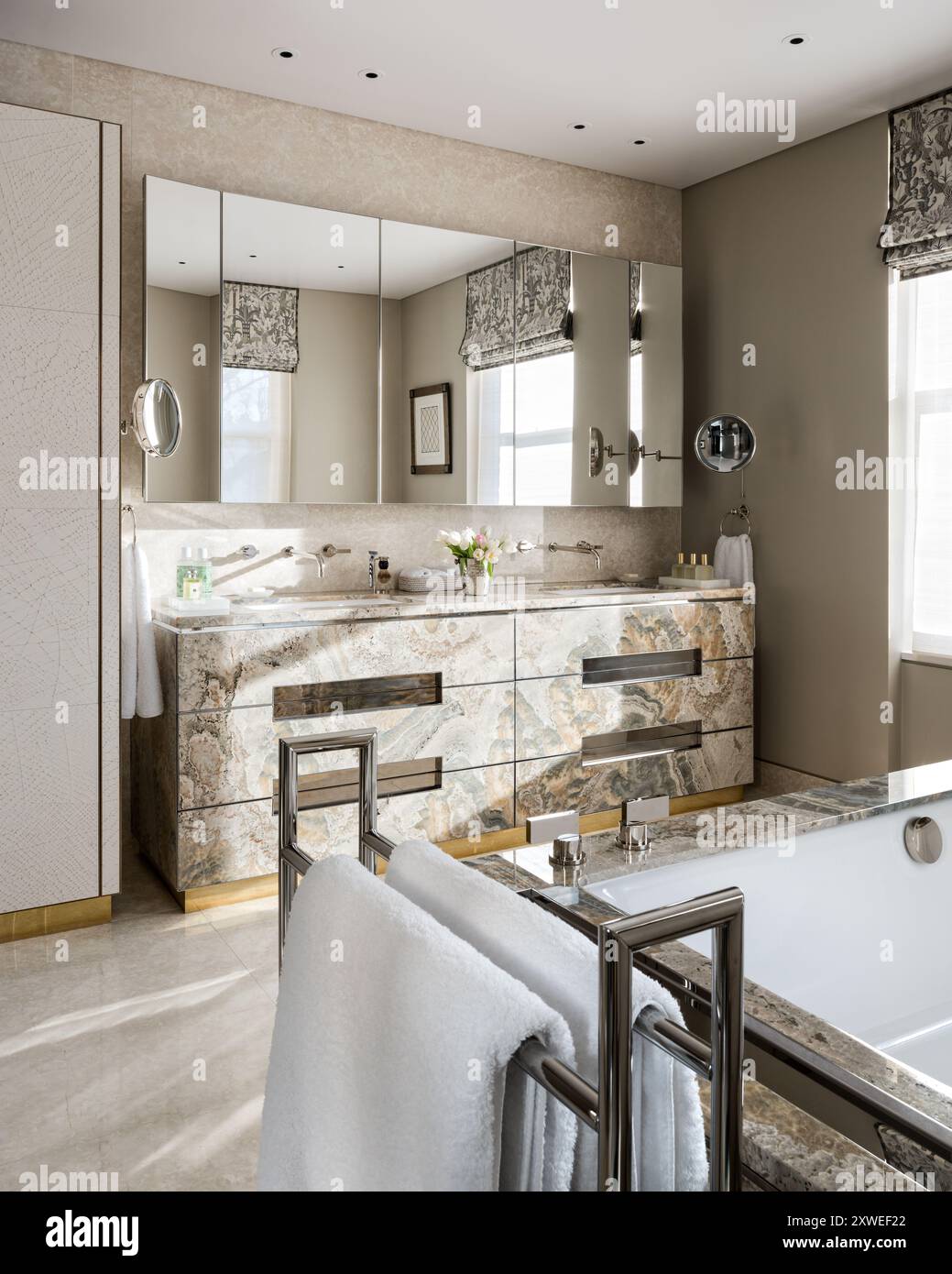 Double wash basin with mirrored cabinets in luxury modern British home ...