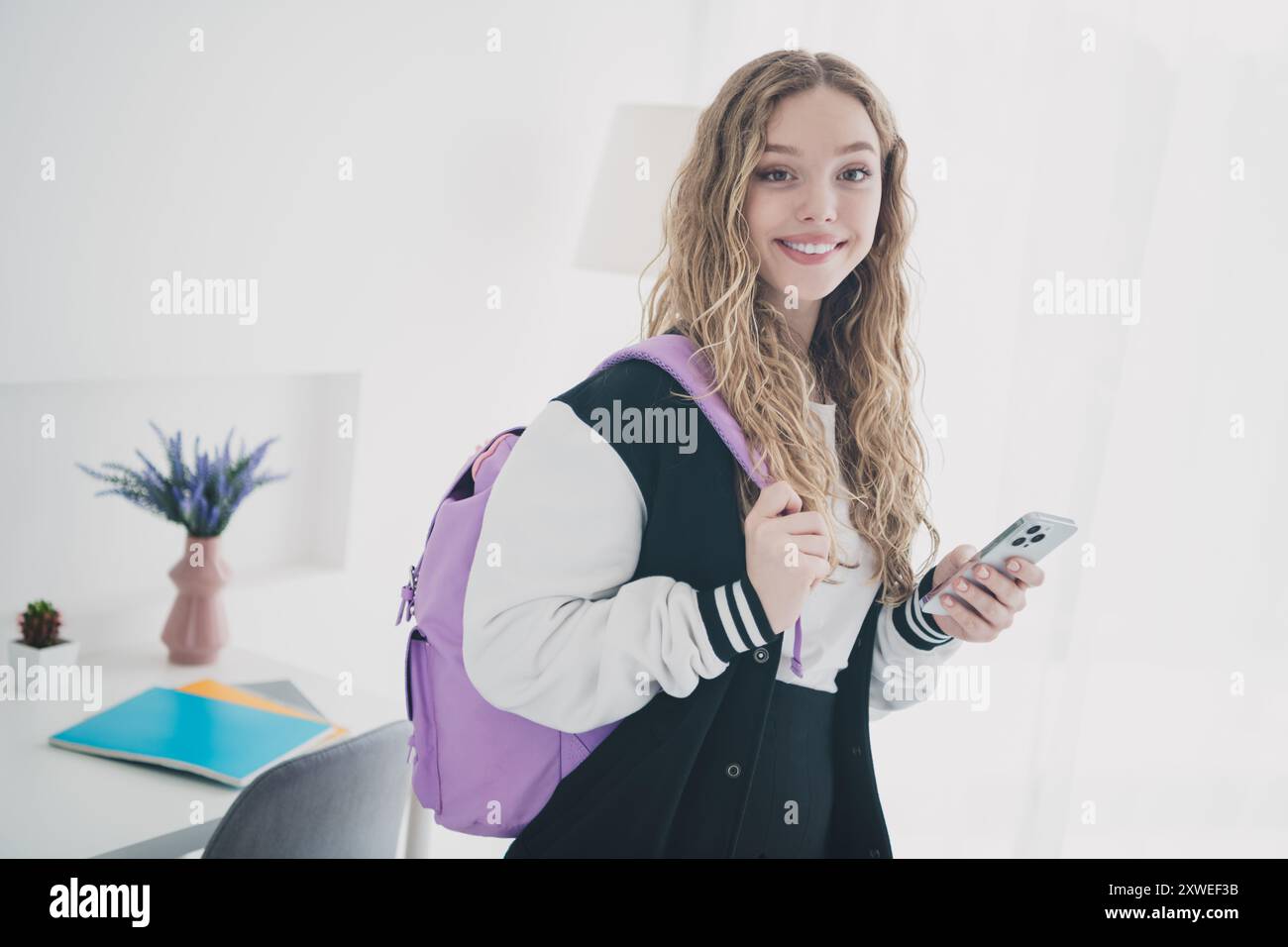 Photo of sweet pretty teen girl hold gadget backpack wear stylish ...