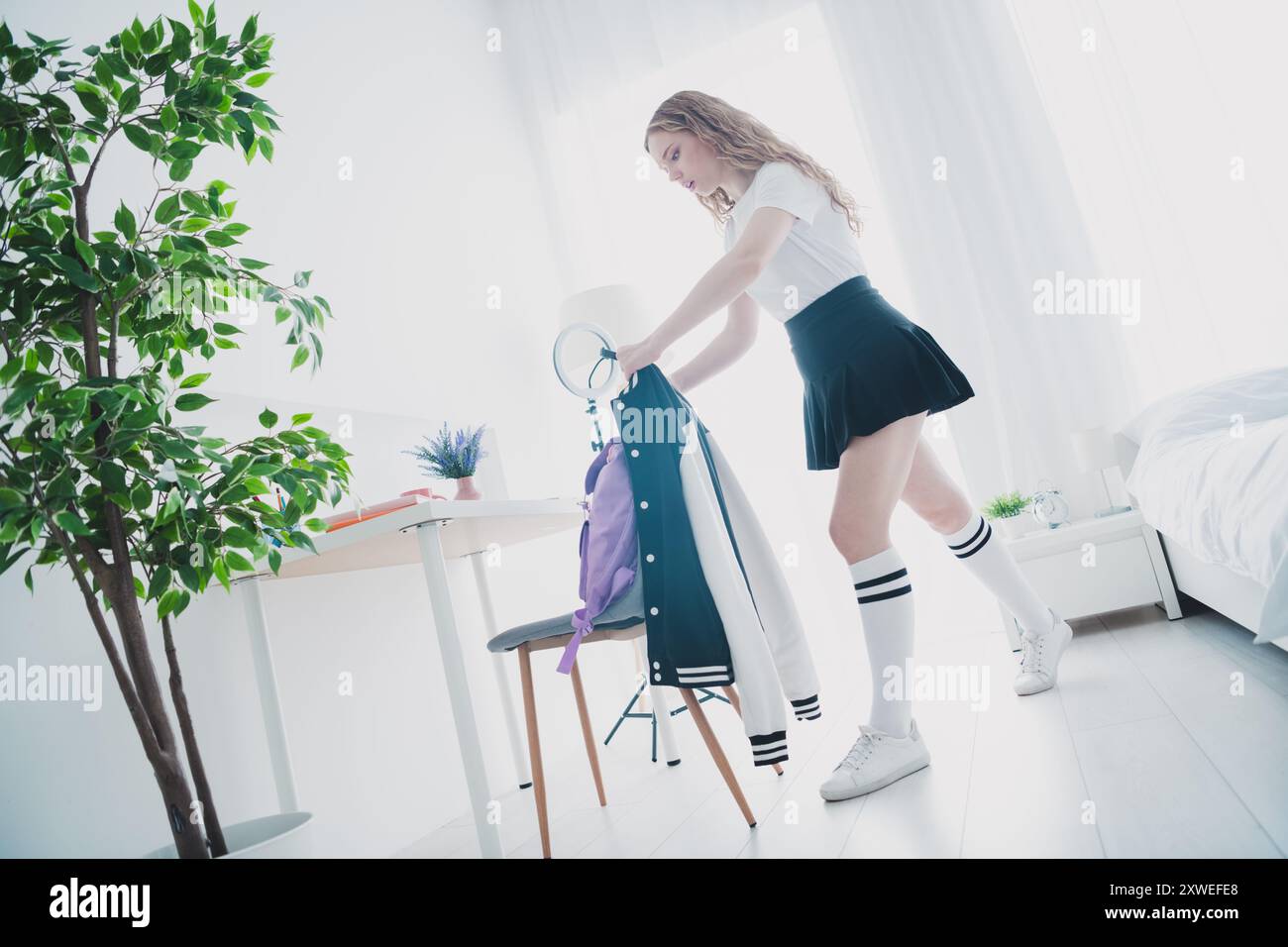 Full body photo of pretty teen girl take jacket hanging chair wear ...