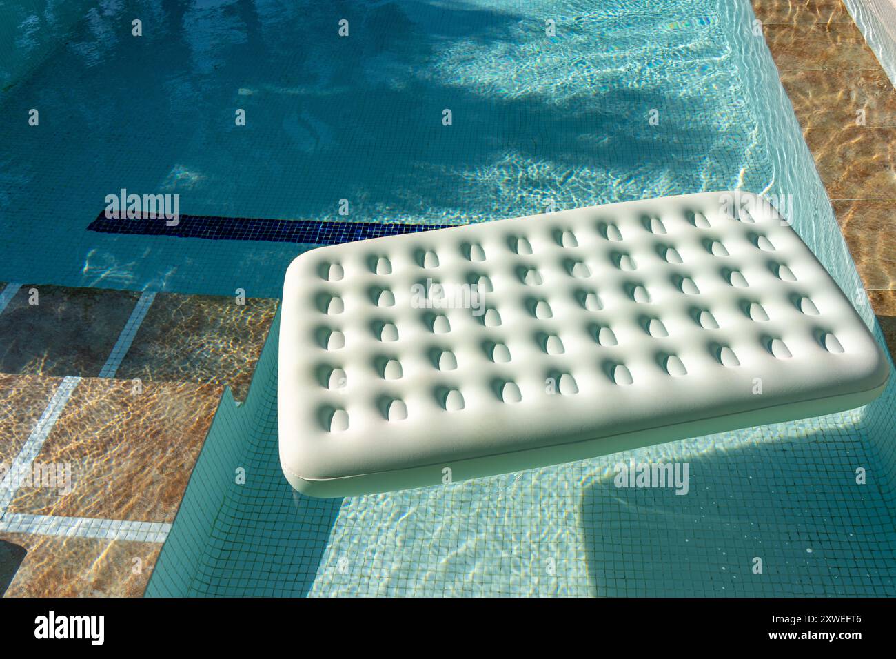 Inflatable mattress floating in swimming pool, top view with space for ...
