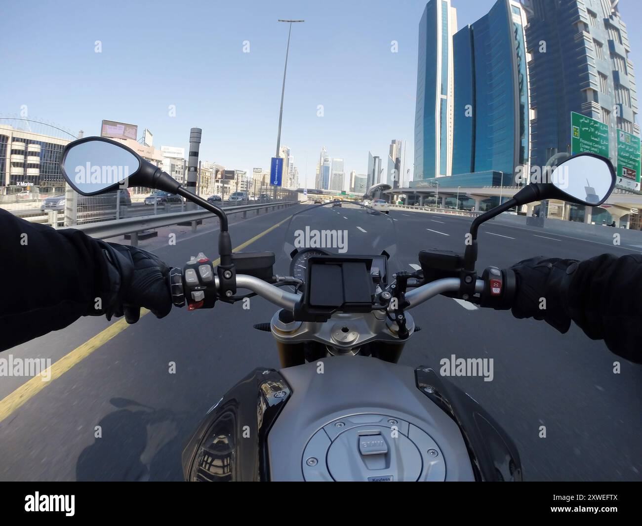 Motorcyclist on Sheikh Zayed Road, Dubai, passing a radar camera on his ...