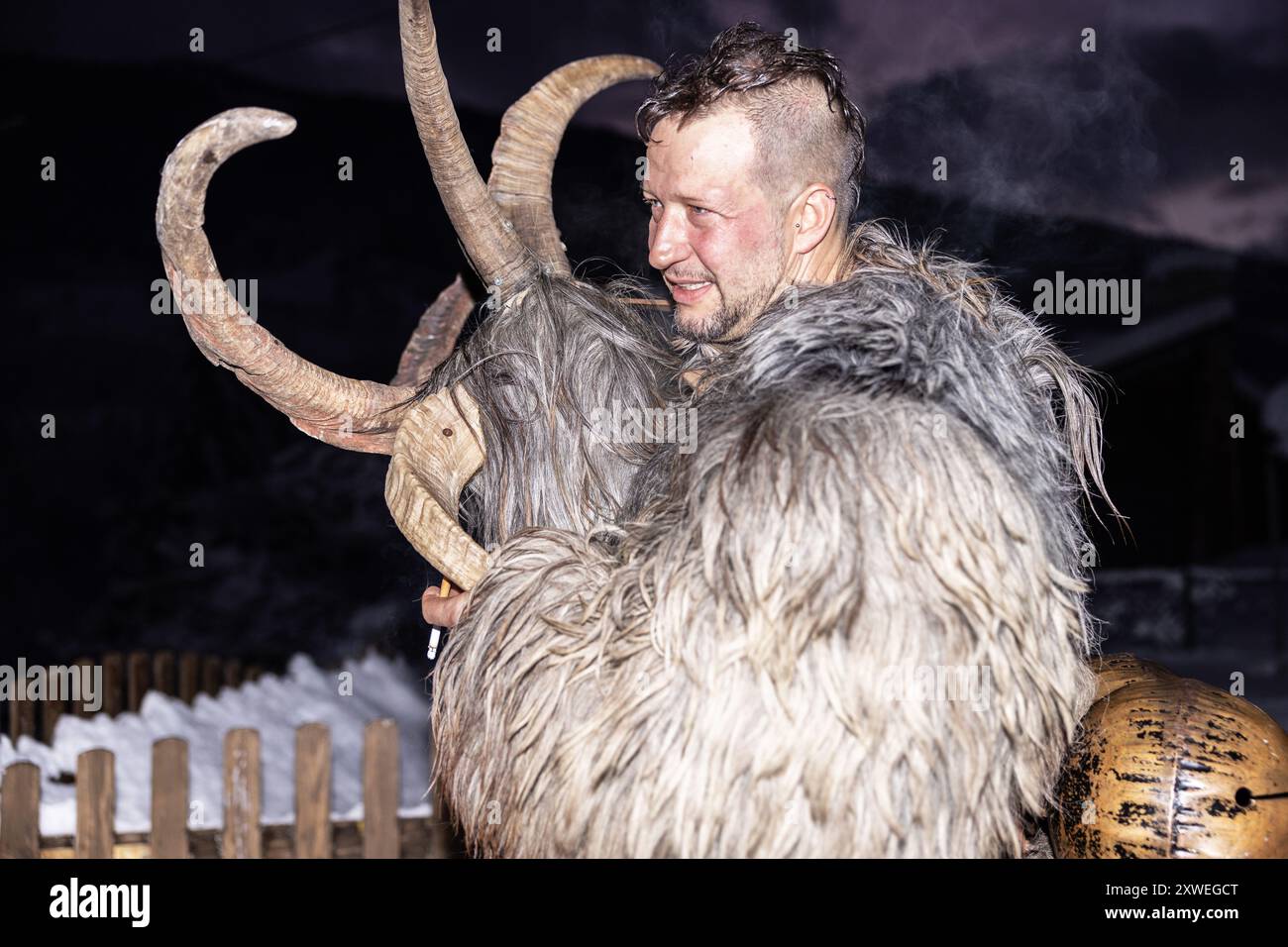 Man in Furry Costume Holds Devil Mask During Nighttime Festival Stock ...