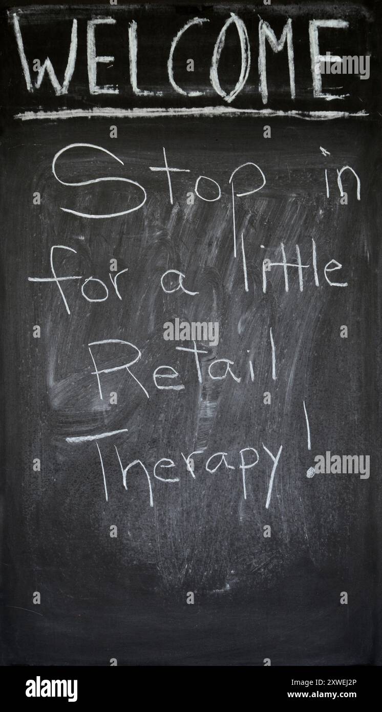 A handmade chalk and blackboard sign on the sidewalk in front of a ...