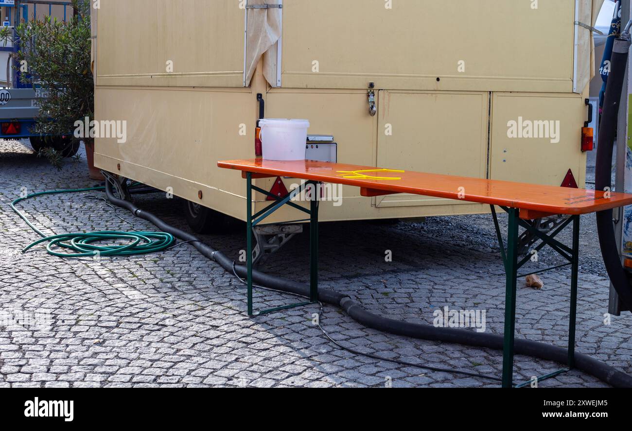 Empty table at street festival. Closed food truck. Street festival ...