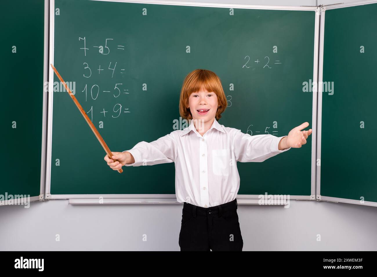 Photo of charming little pupil boy hold stick pointer want hug excited ...