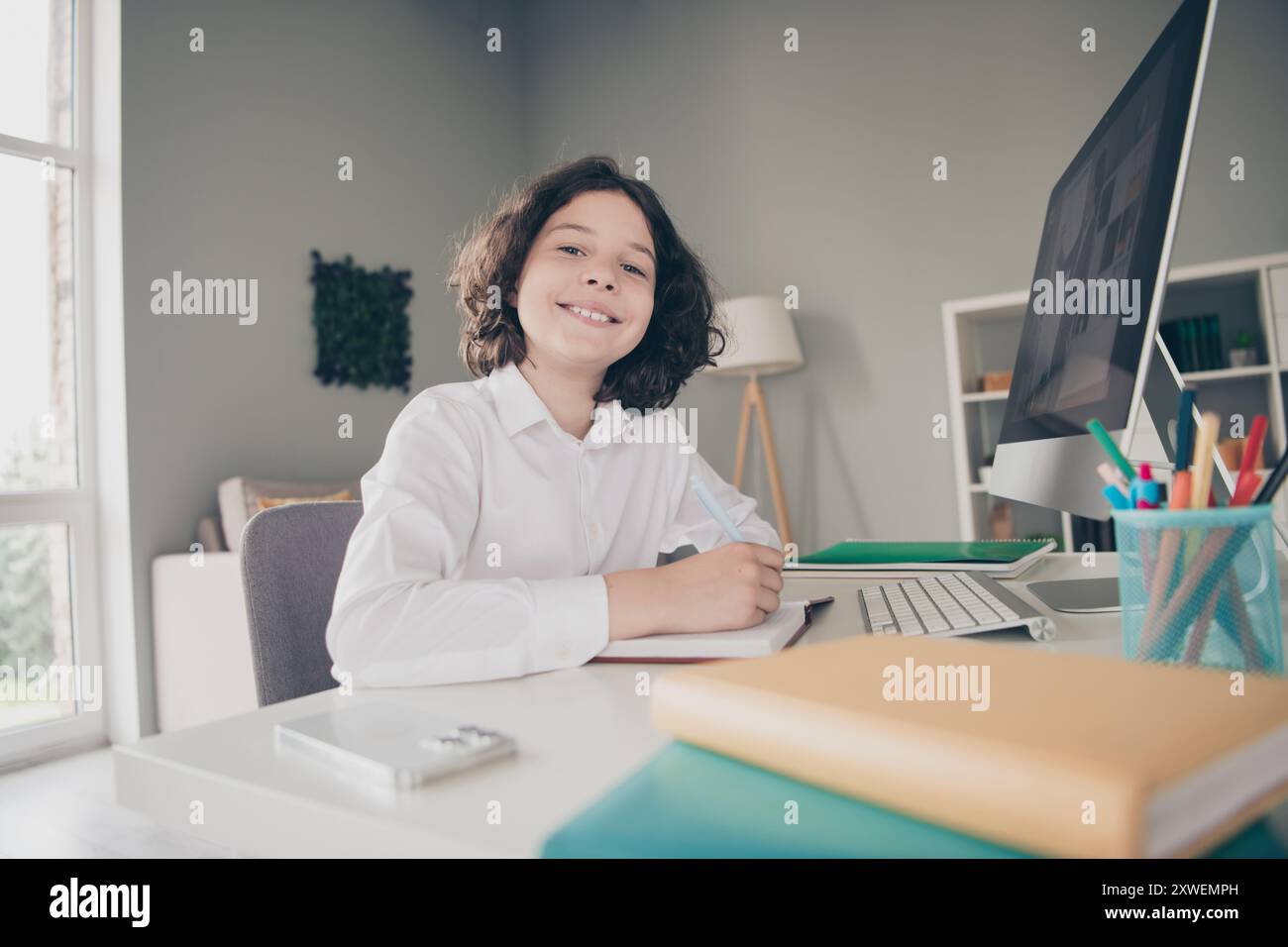 Photo of charming cute intelligent little boy schoolkid wearing white ...