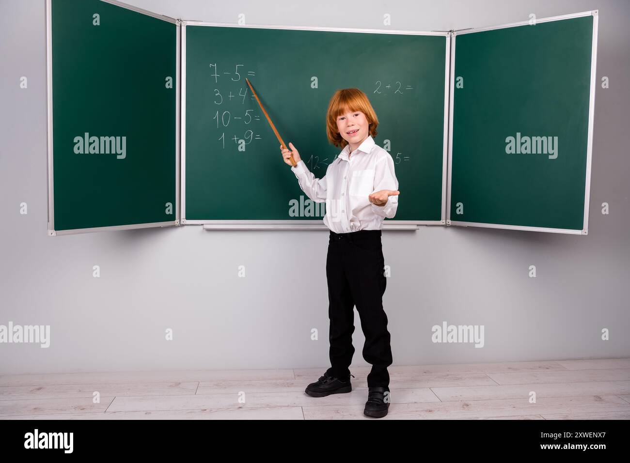 Full length photo of lovely small schoolboy teacher hold pointer stick ...