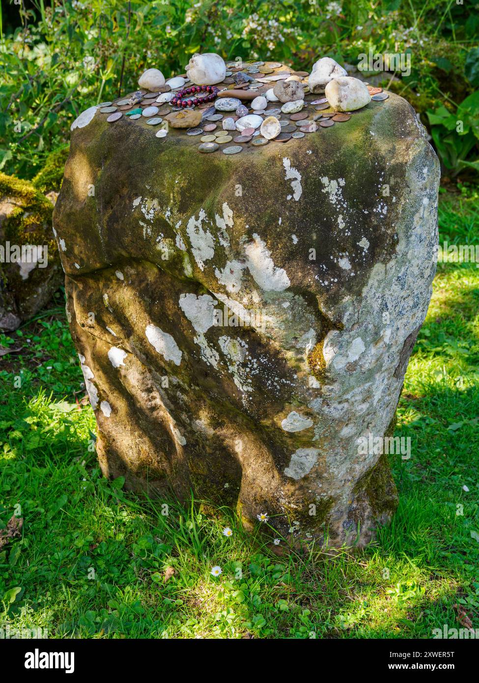 An ancient stone with offerings in the graveyard of Dunino Parish ...