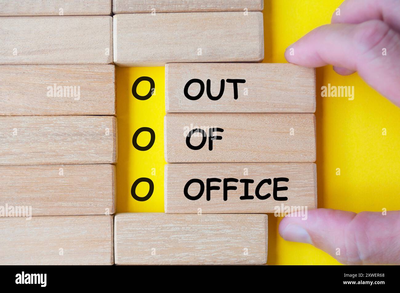Hand pulling wooden blocks with Out Of Office. Out of office concept ...